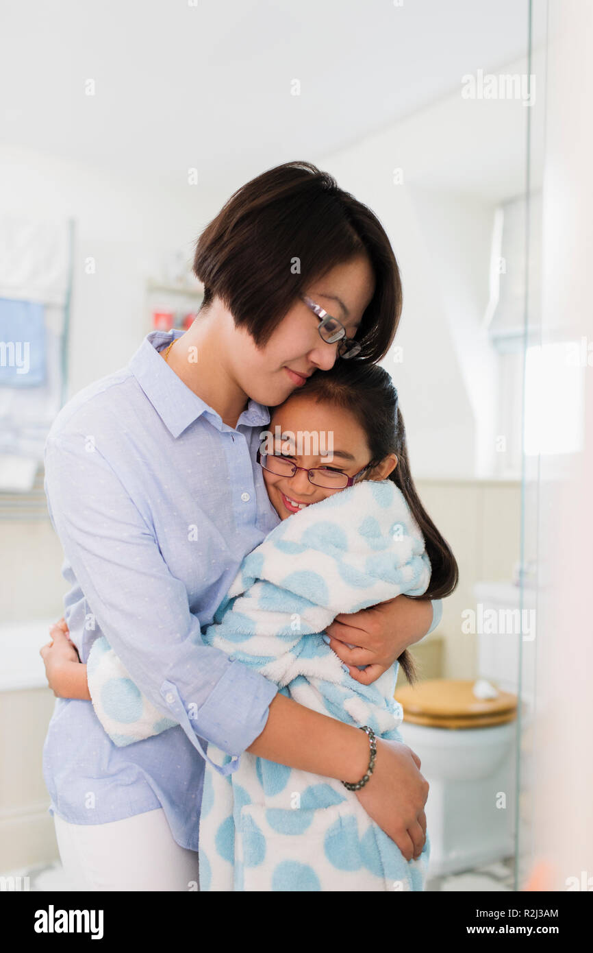 Affectionate mother and daughter hugging in bathroom Stock Photo - Alamy