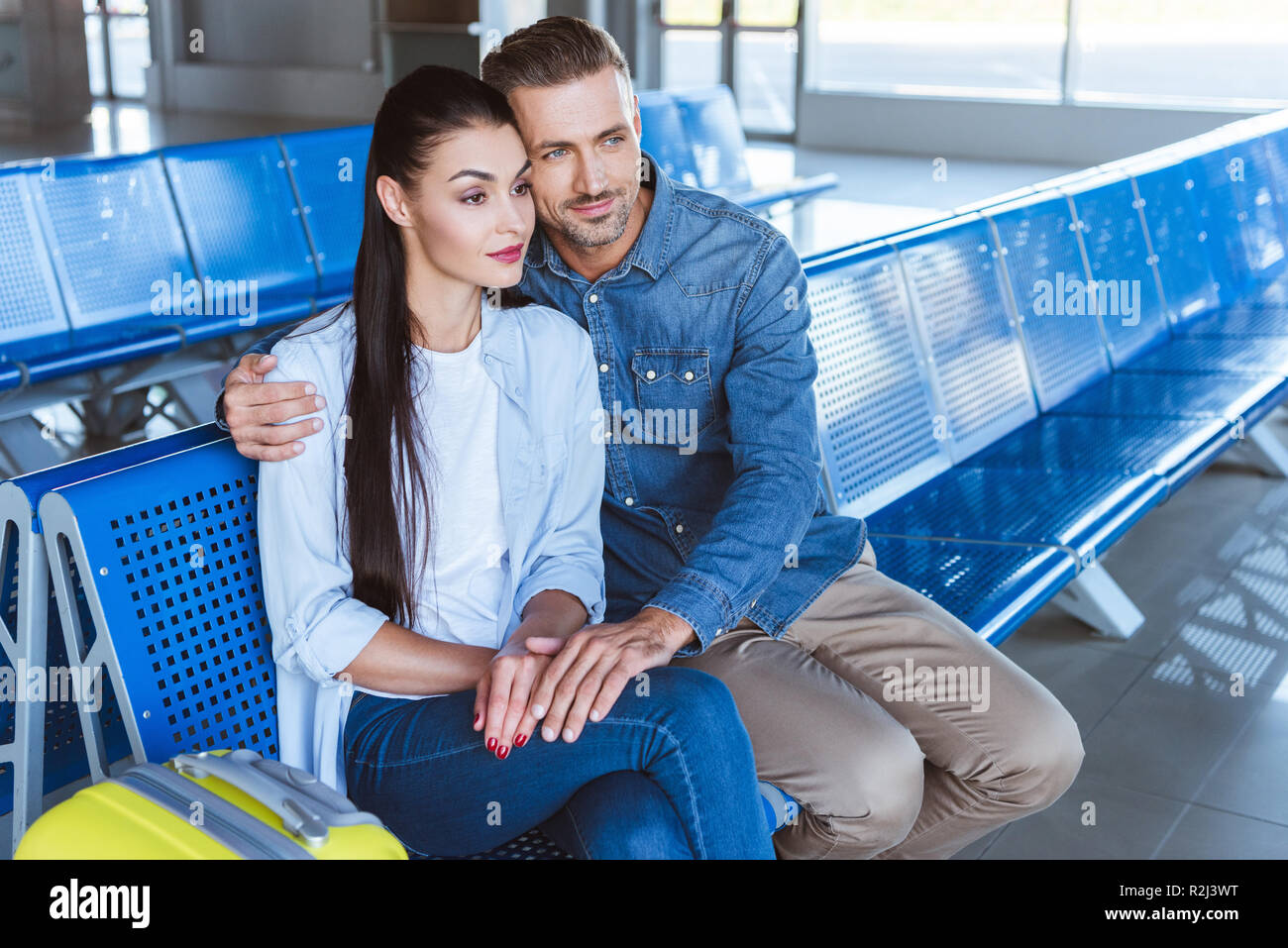 A couple hugging and waiting for the plane in the airport Stock Photo ...