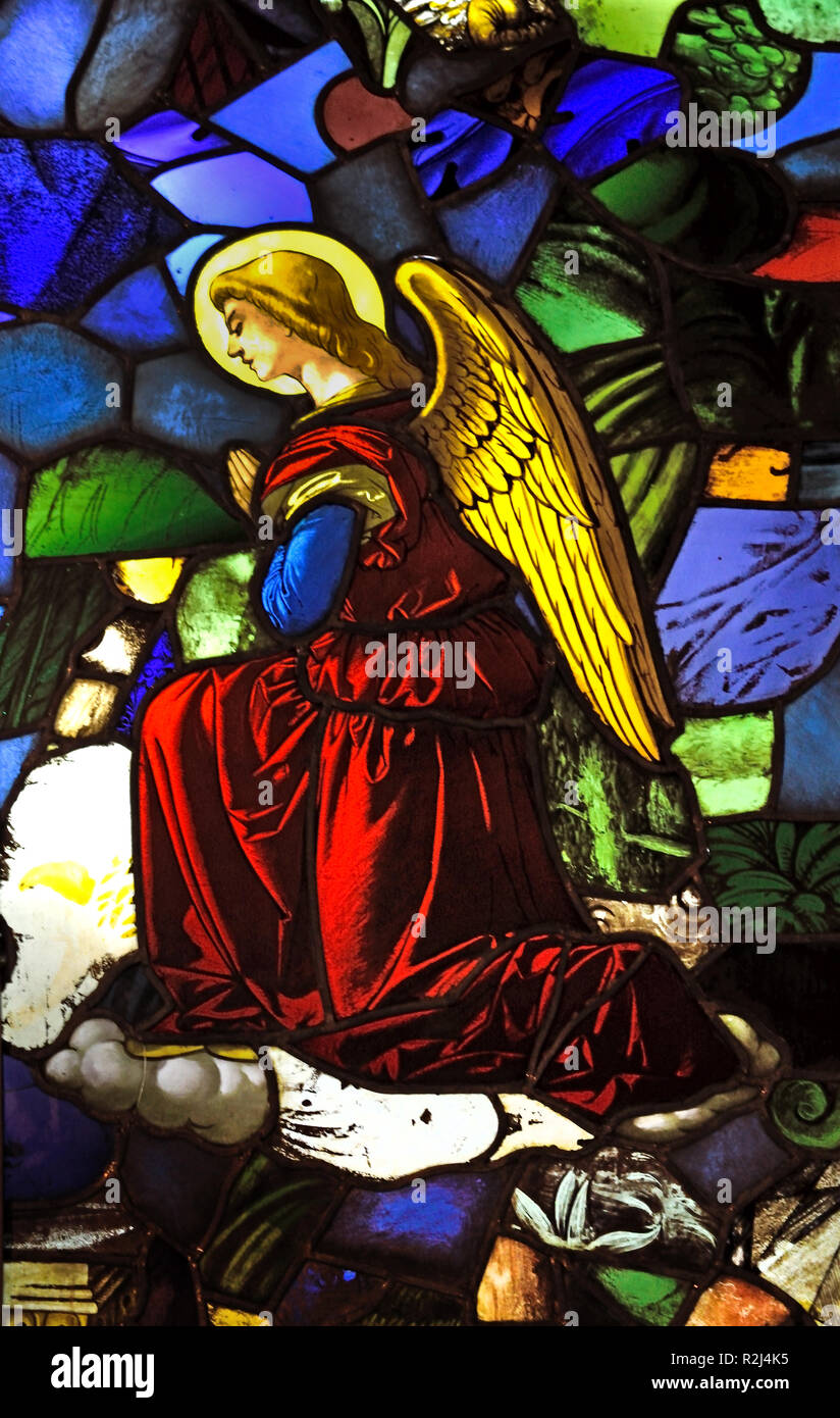 Cathedral's stained glass windows: a large Angel in prayer and an Angel ...