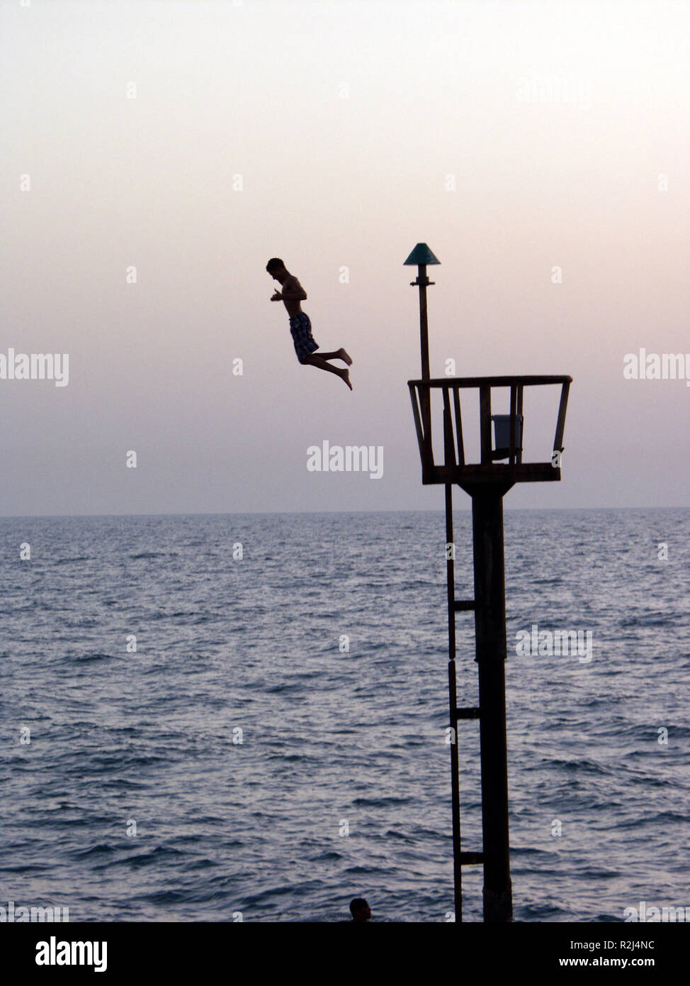 Guys jumping into sea hi-res stock photography and images - Alamy