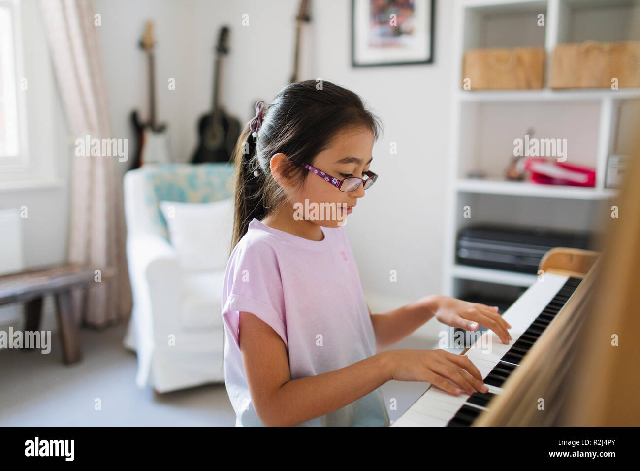 Girl playing piano Stock Photo - Alamy