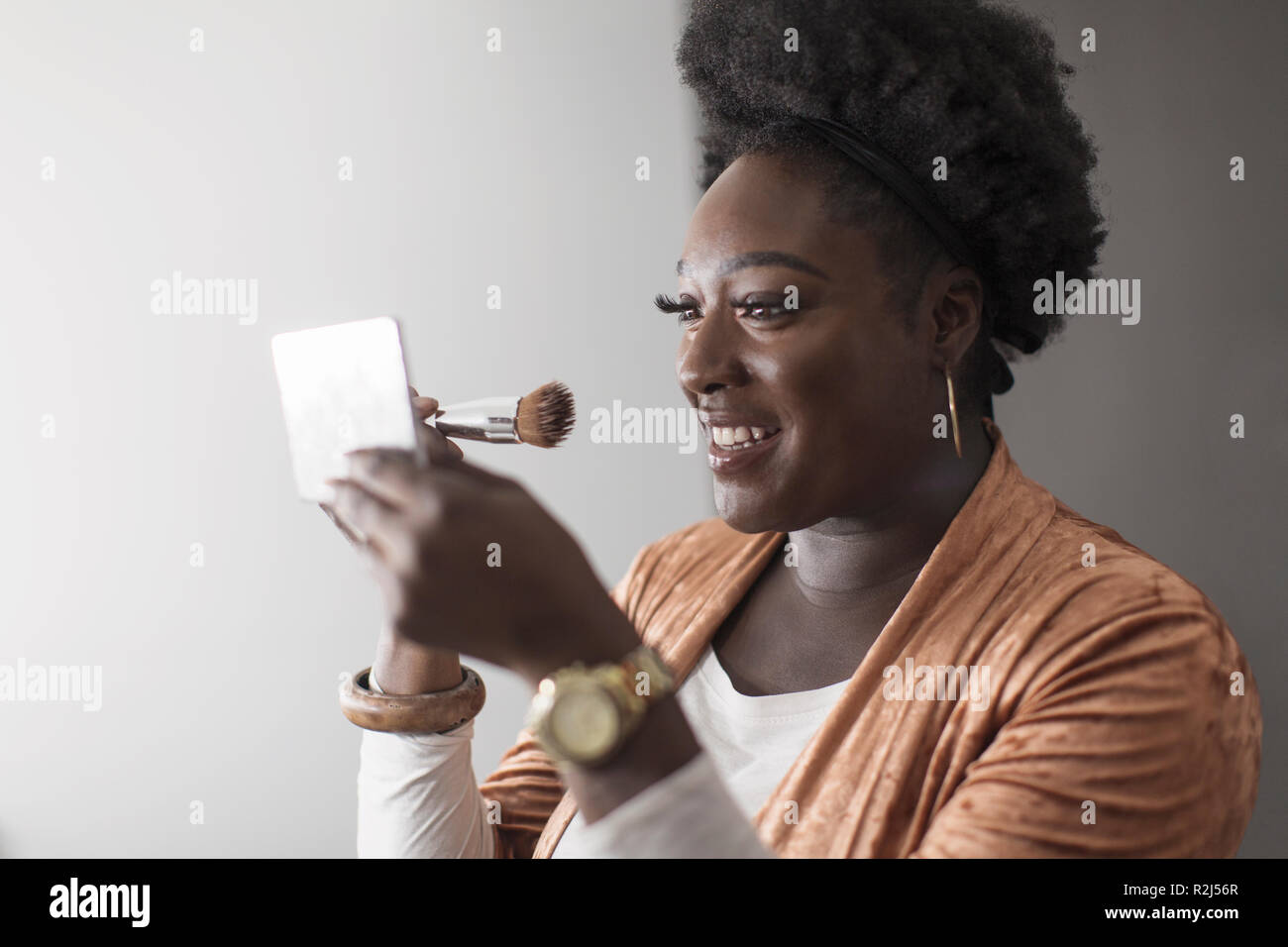 Looking in compact mirror hi-res stock photography and images - Alamy