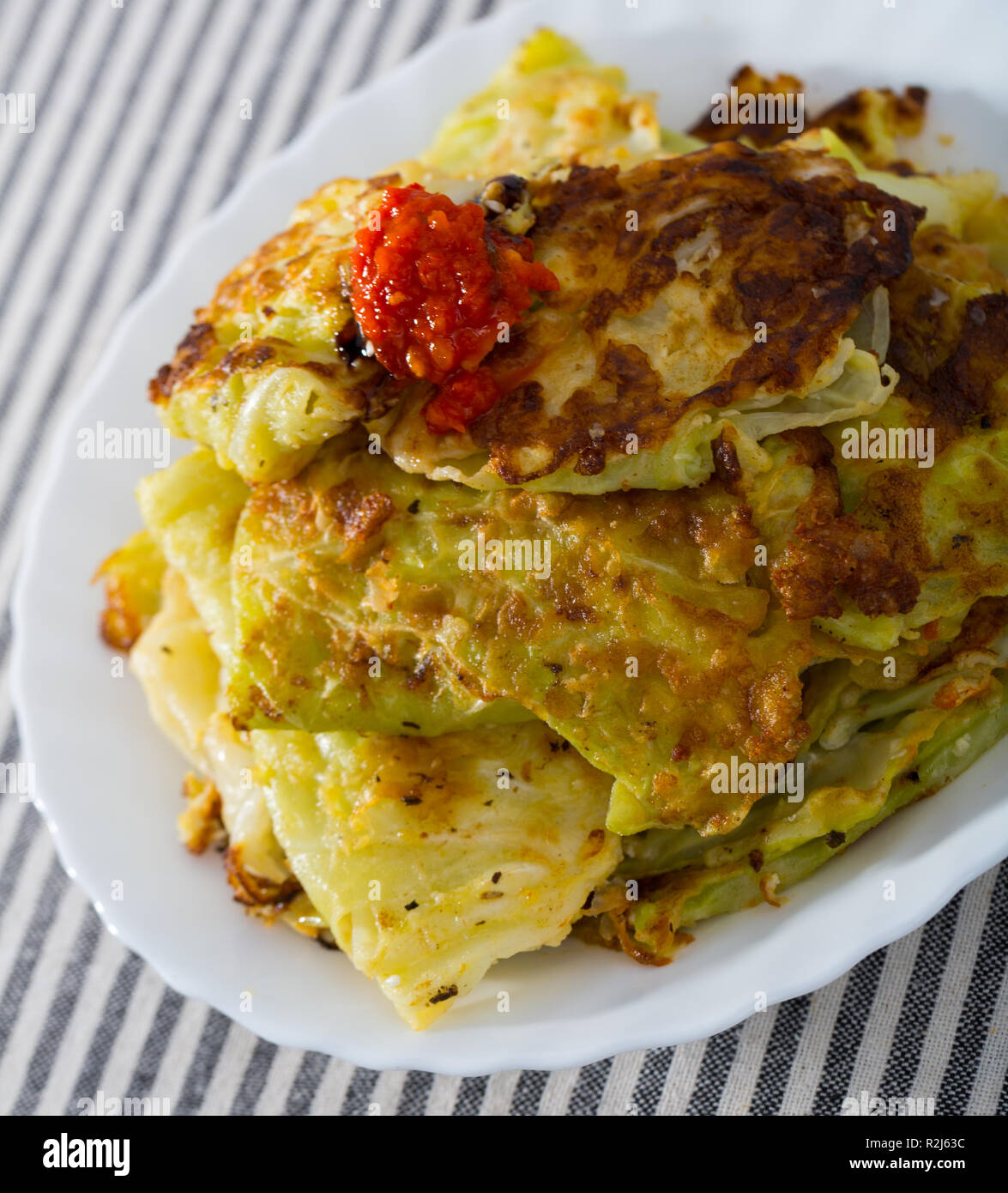 Image of cabbage leaves in batter on the plate indoors Stock Photo - Alamy