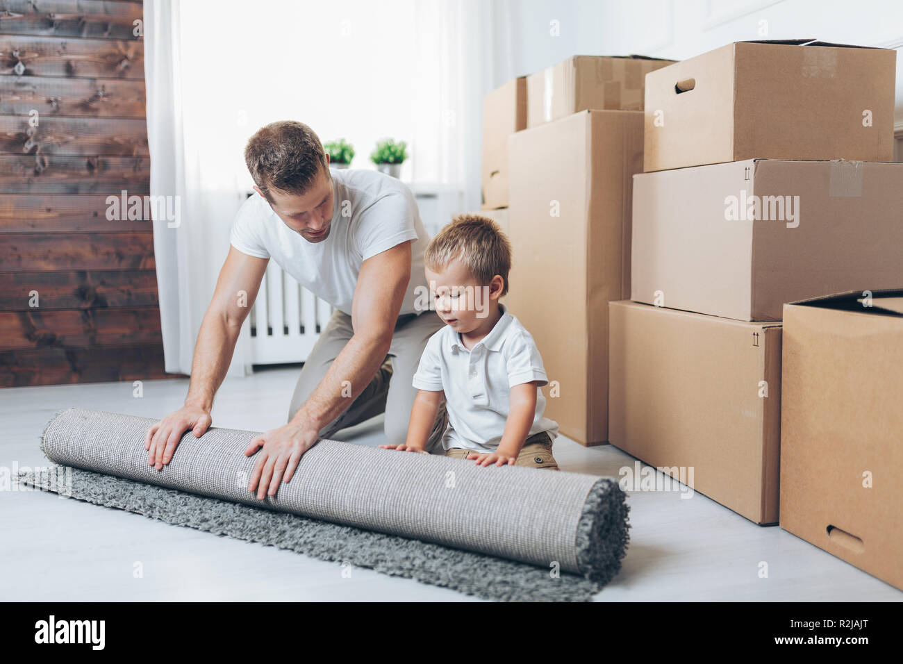 Moving concept, Father and his son moving into their new home Stock ...