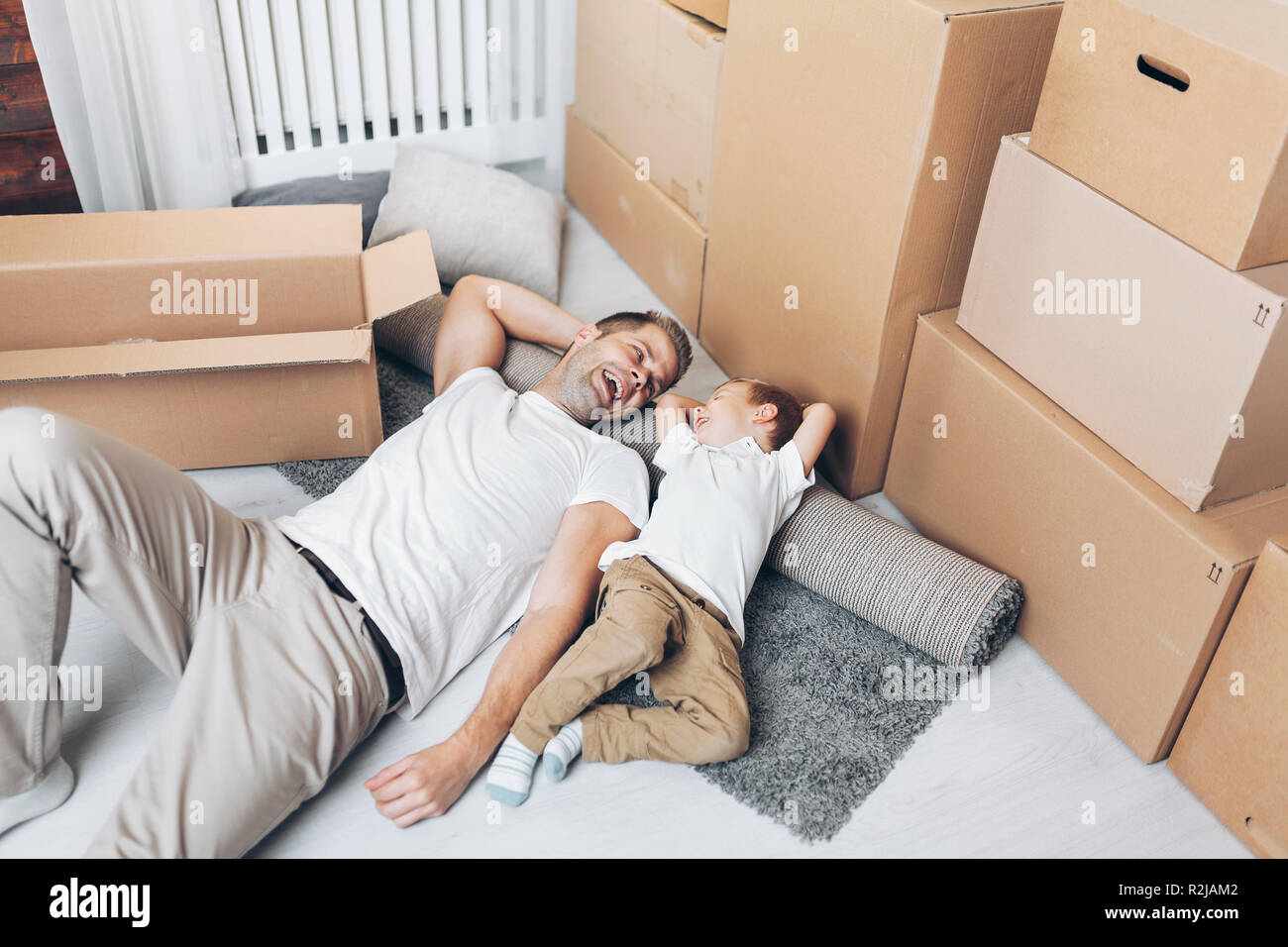 Moving concept, Father and his son moving into their new home Stock ...