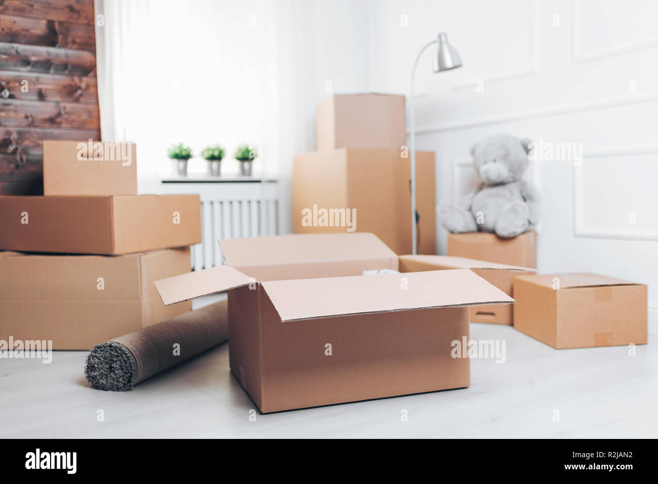 Moving concept. Room full of cardboard boxes Stock Photo - Alamy
