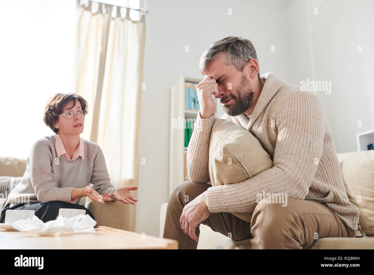 Upset patient crying at psychiatrists session Stock Photo - Alamy