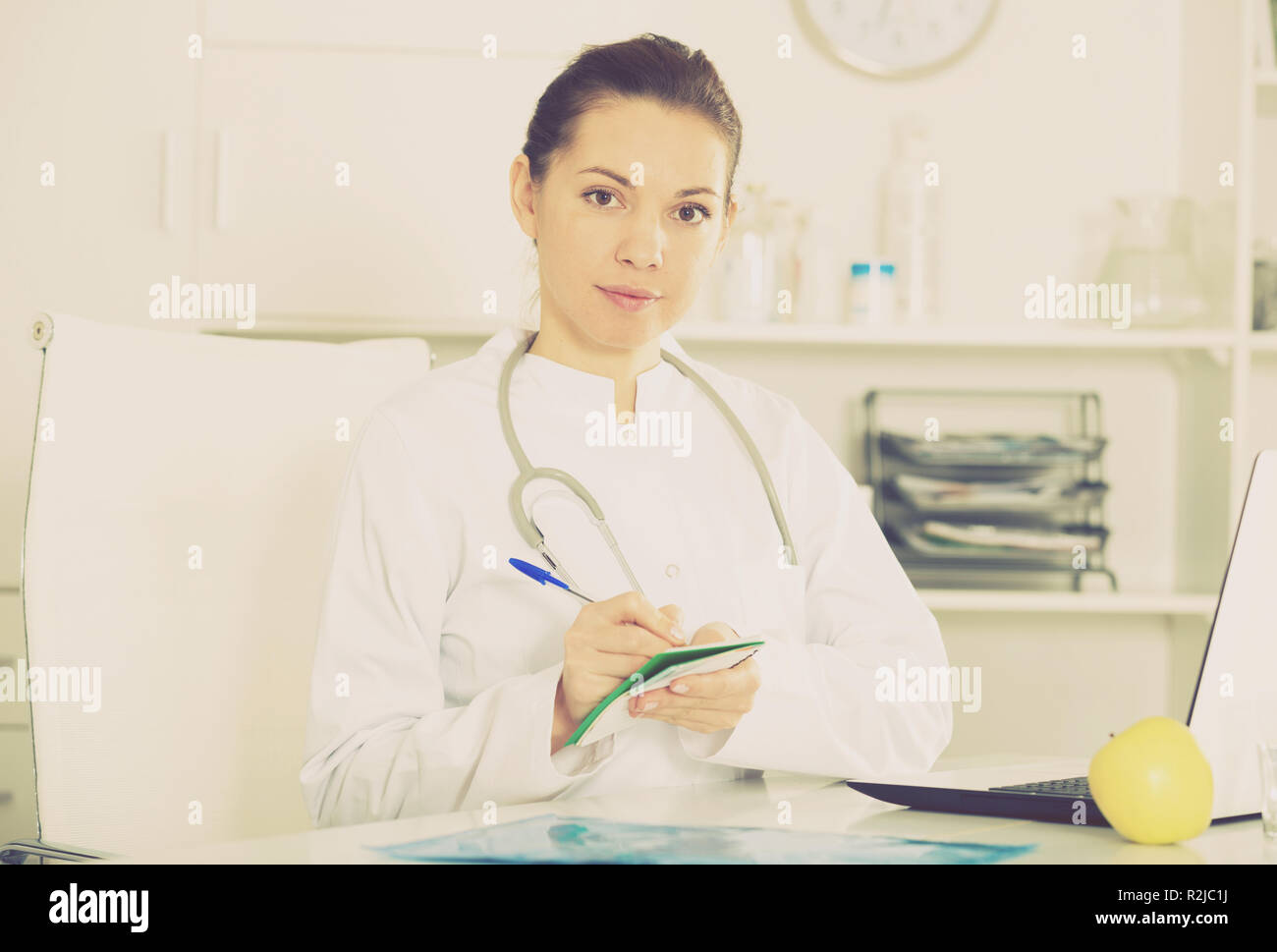 Female doctor having a productive day helping in her office Stock Photo ...