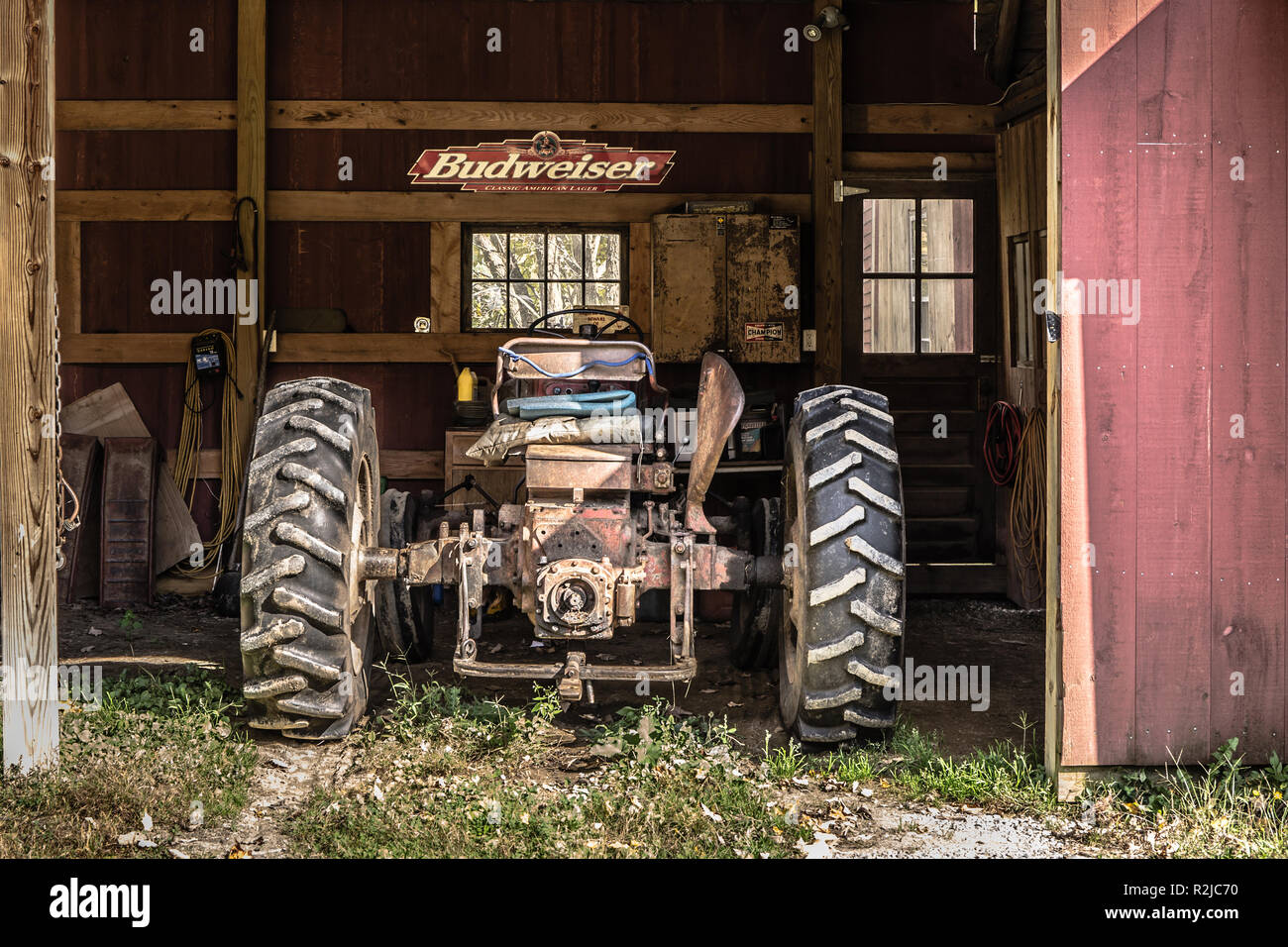 An old vintage tractor stored in an old wooden barn in Vermont Stock ...