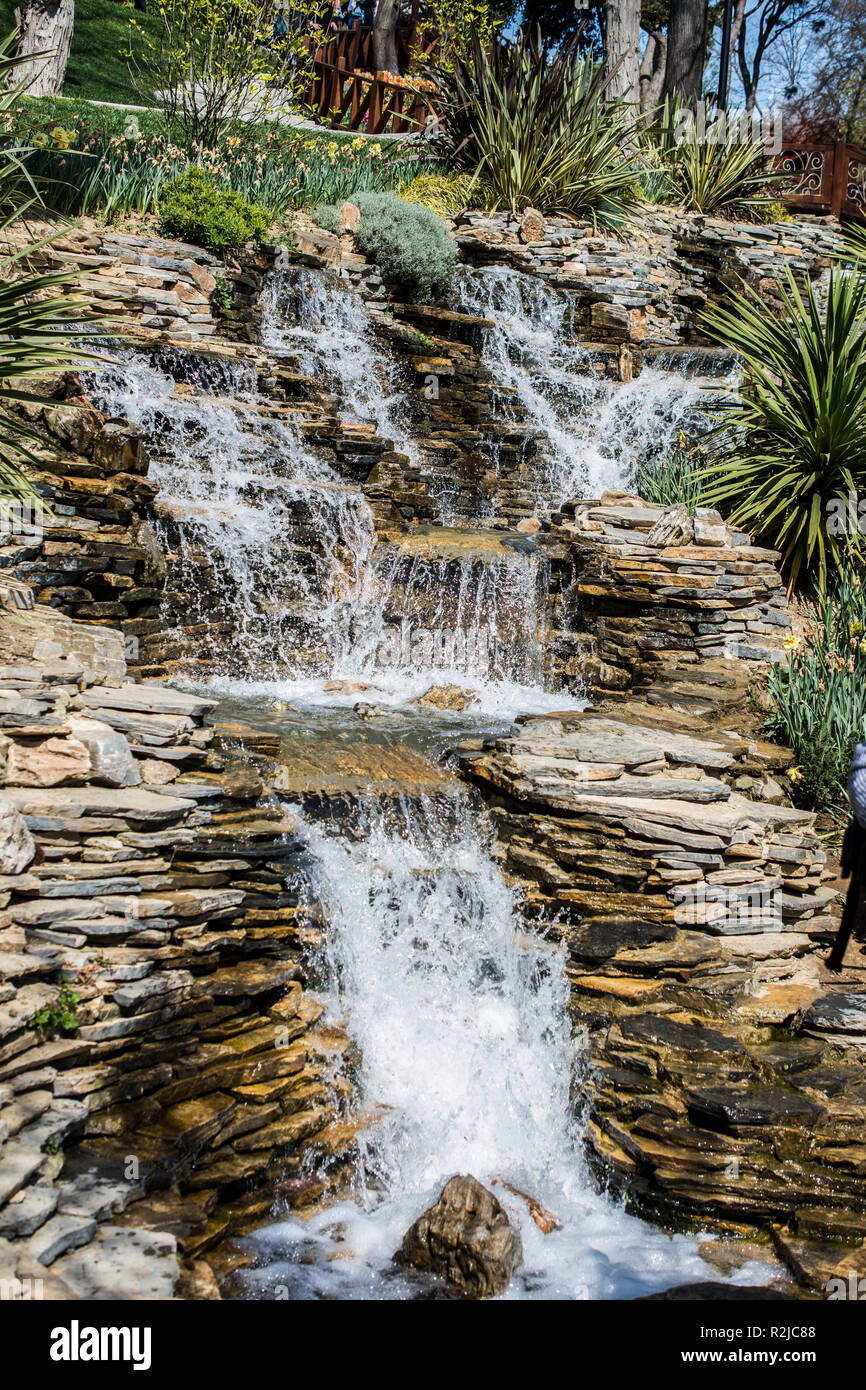Small rocky waterfall pouring into a small lake Stock Photo - Alamy