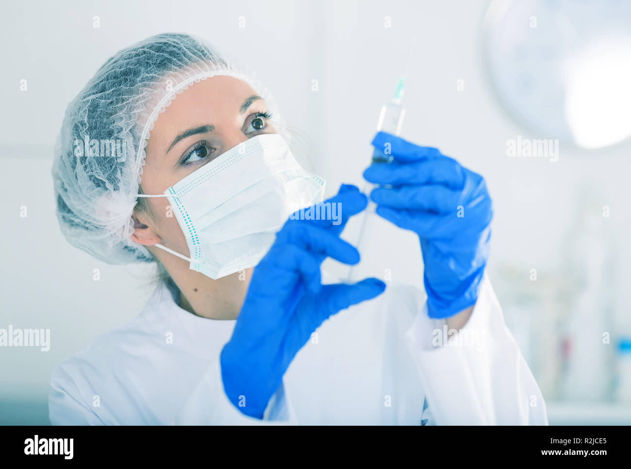 Female nurse holding syringe for injection in hospital Stock Photo - Alamy