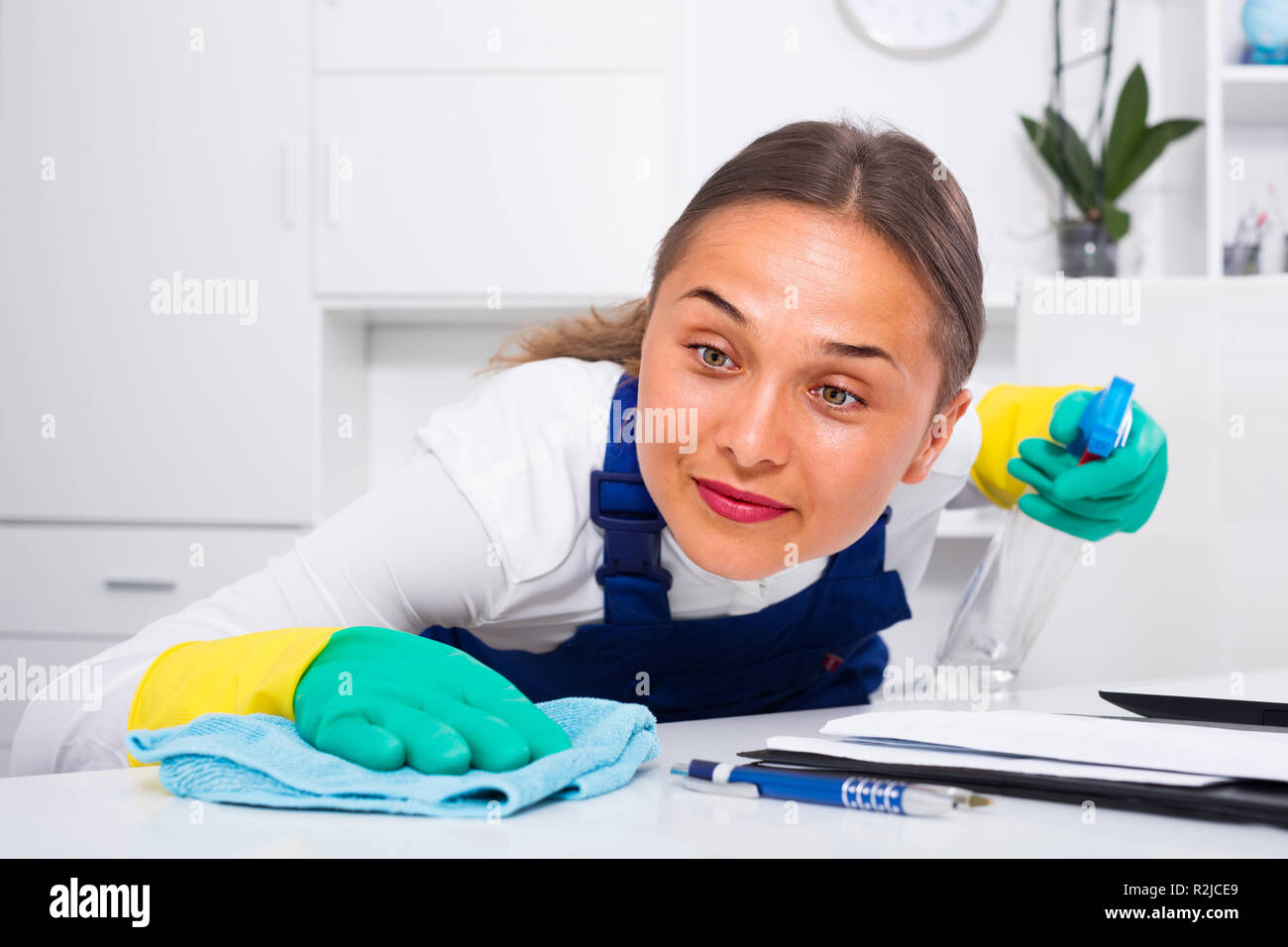 portrait of cheerful young female cleaner 30s with duster at office ...