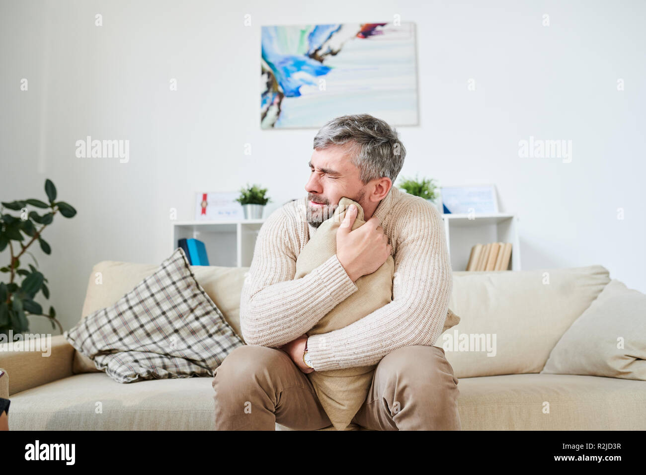 Sad man crying while dealing with personal issues at therapy Stock ...