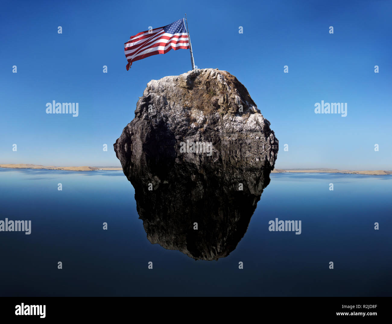 Flag of The United State Of America on top of isolated peace of land ...