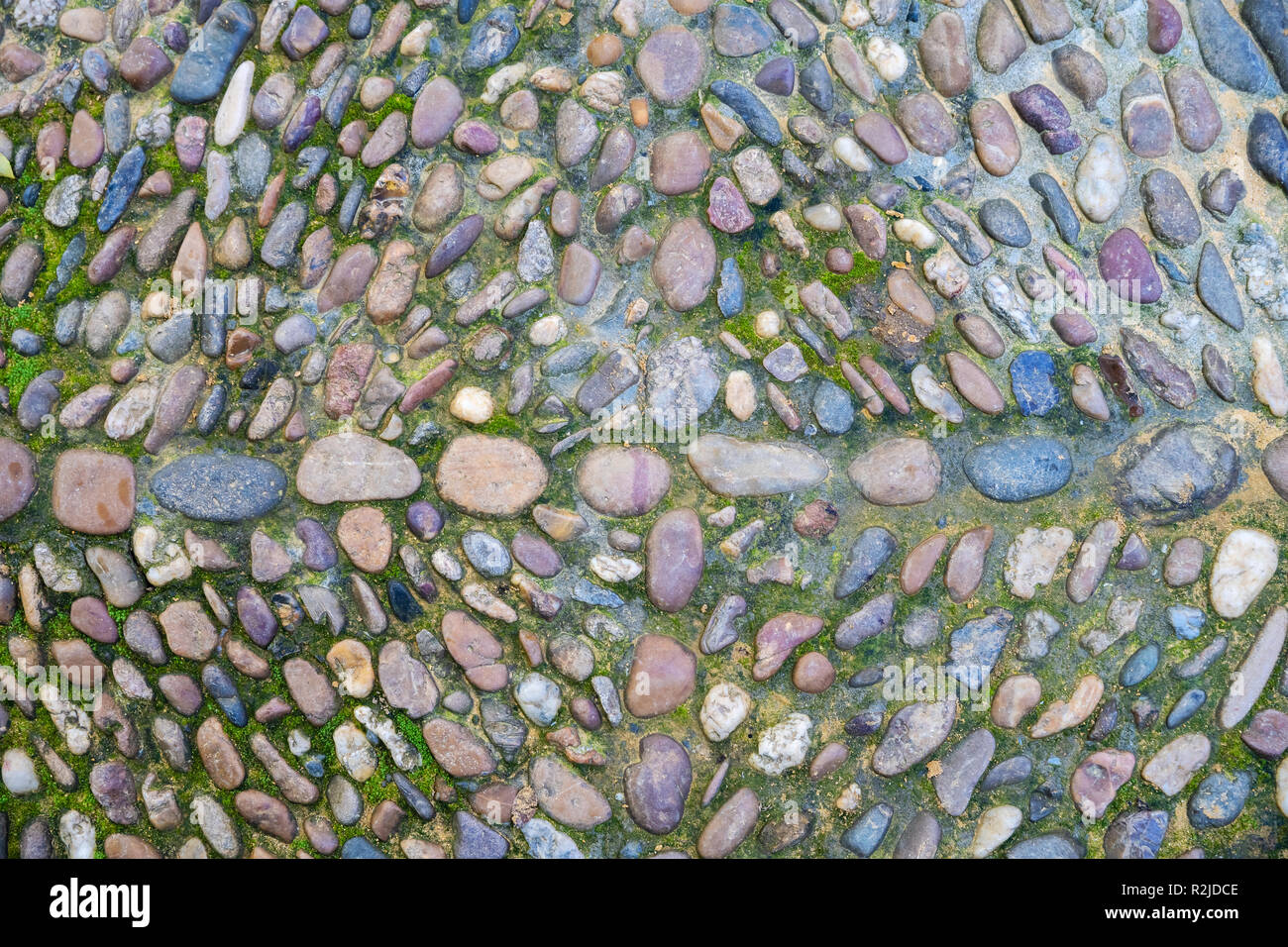 patterned background texture from pebbles pavement Stock Photo - Alamy