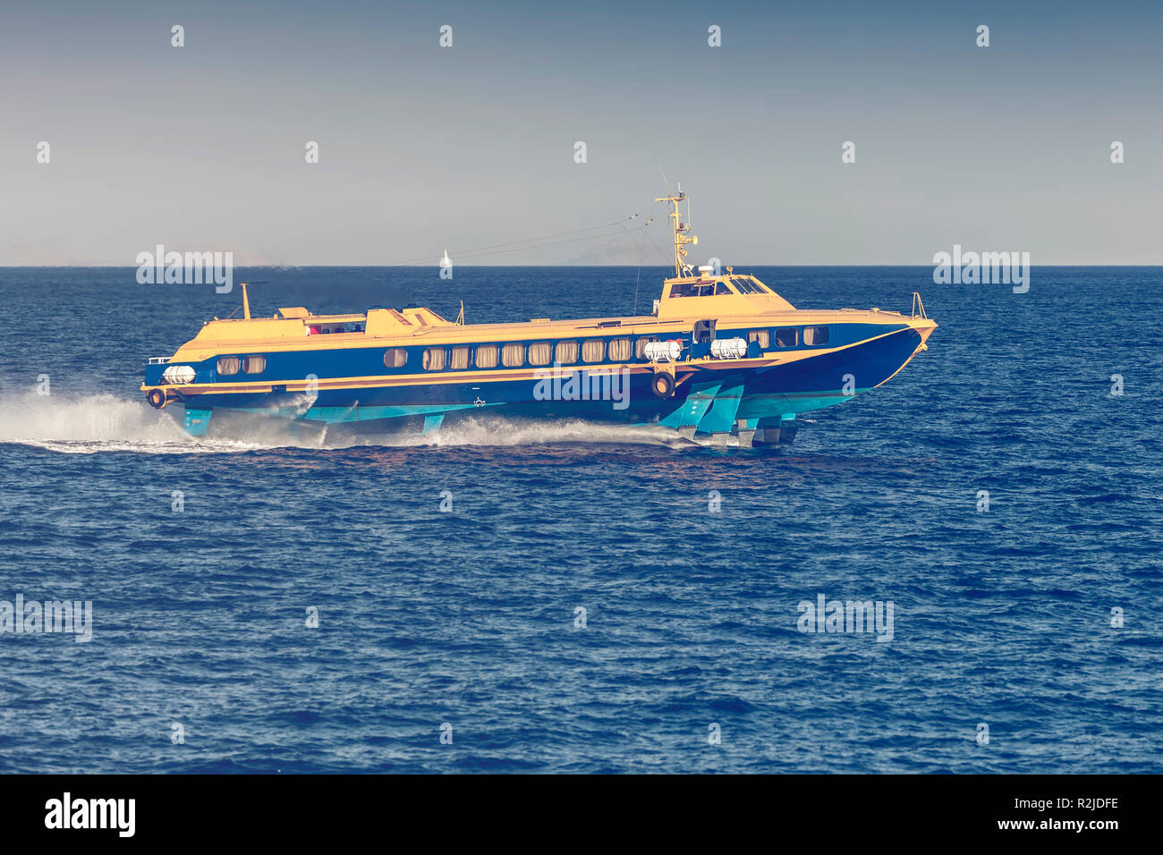 Fast ferry boat in the see, used to carry passengers and cargo. Vintage ...