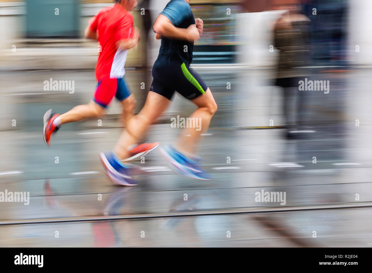 running men in the rainy city, picture made with motion blur effect ...