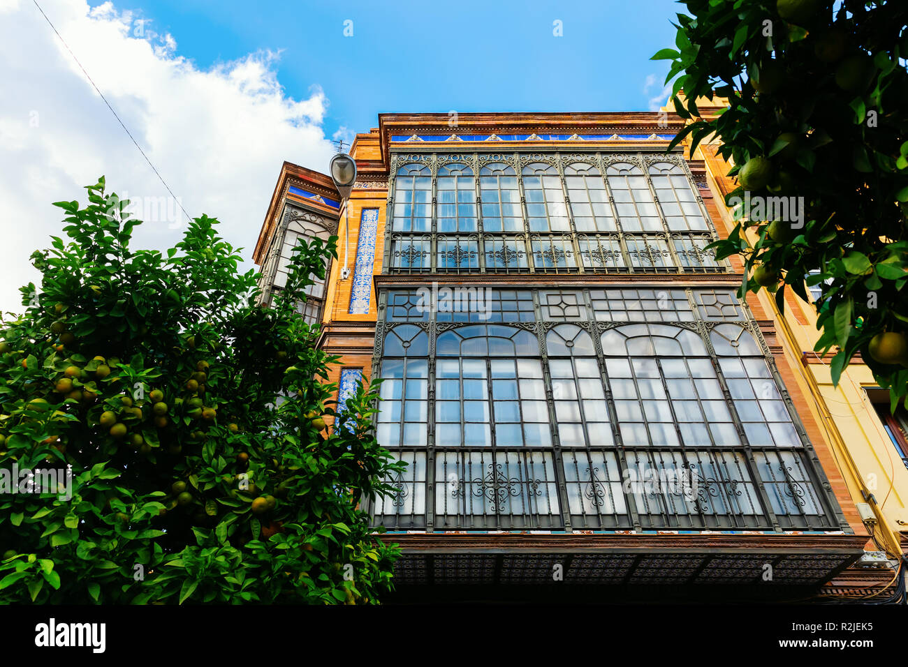 facade with decorative windows of a typical building in Seville, Spain ...