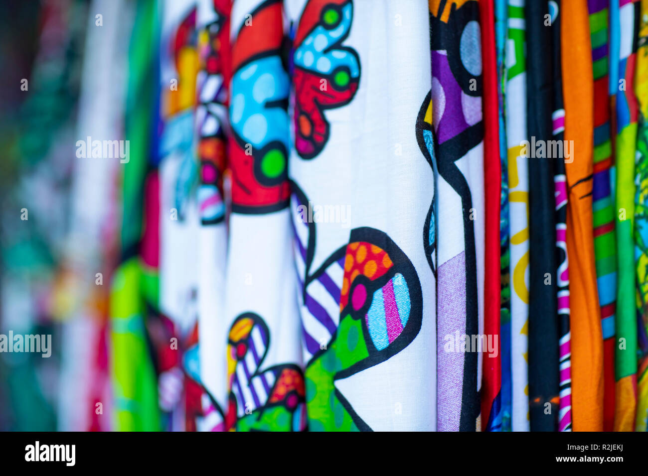 Colorful fabrics hanging and lined. Fabrics with different patterns and ...