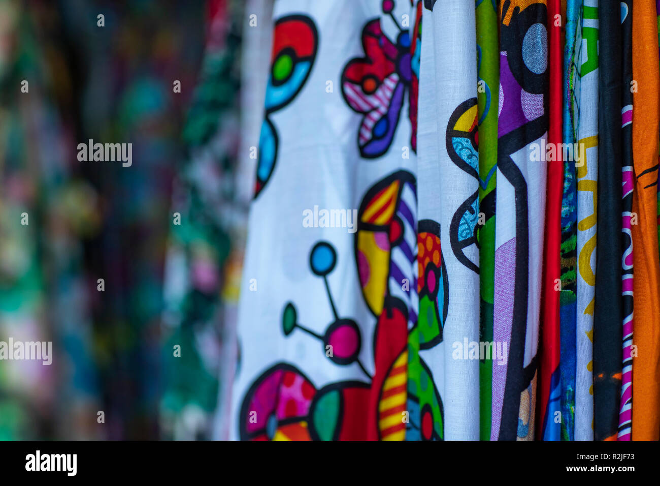 Colorful fabrics hanging and lined. Fabrics with different patterns and ...