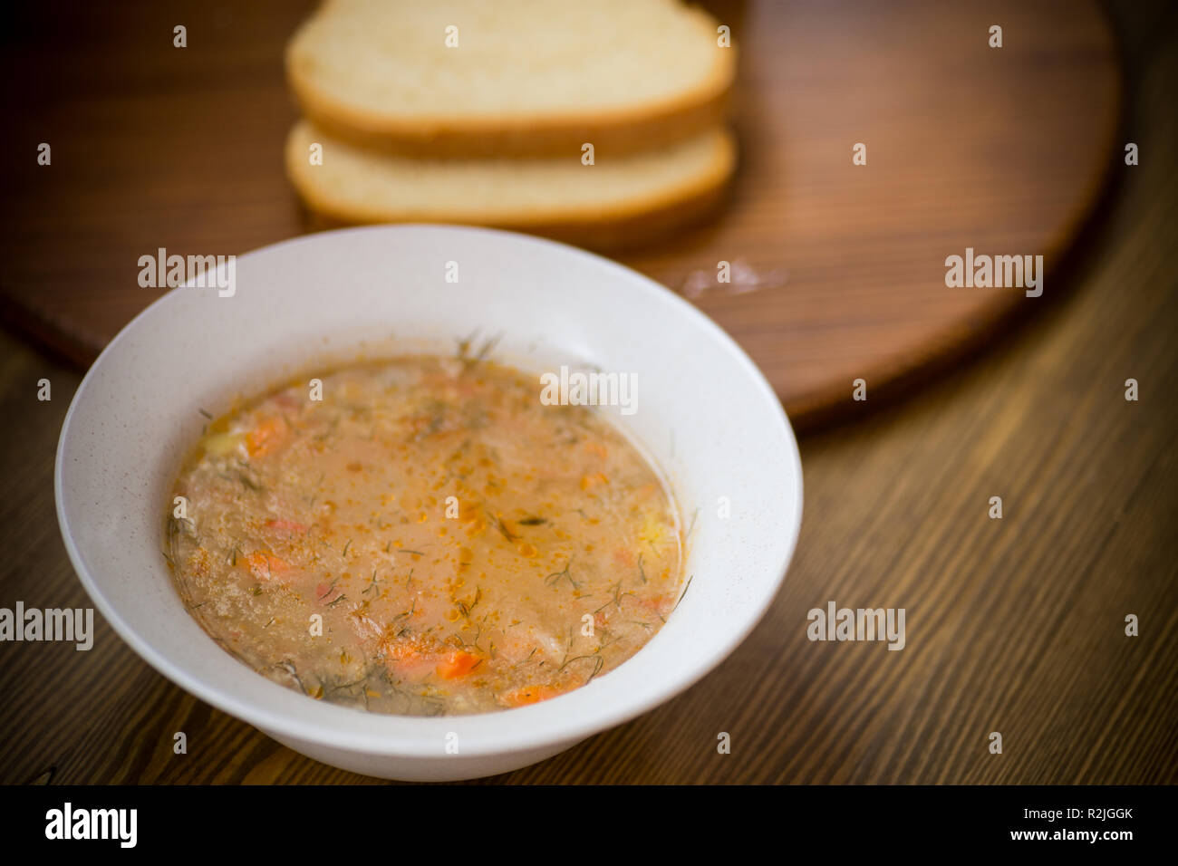 lean soup with vegetables and groats in a plate on a wooden table Stock ...