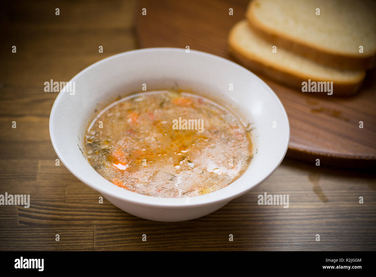 lean soup with vegetables and groats in a plate on a wooden table Stock ...