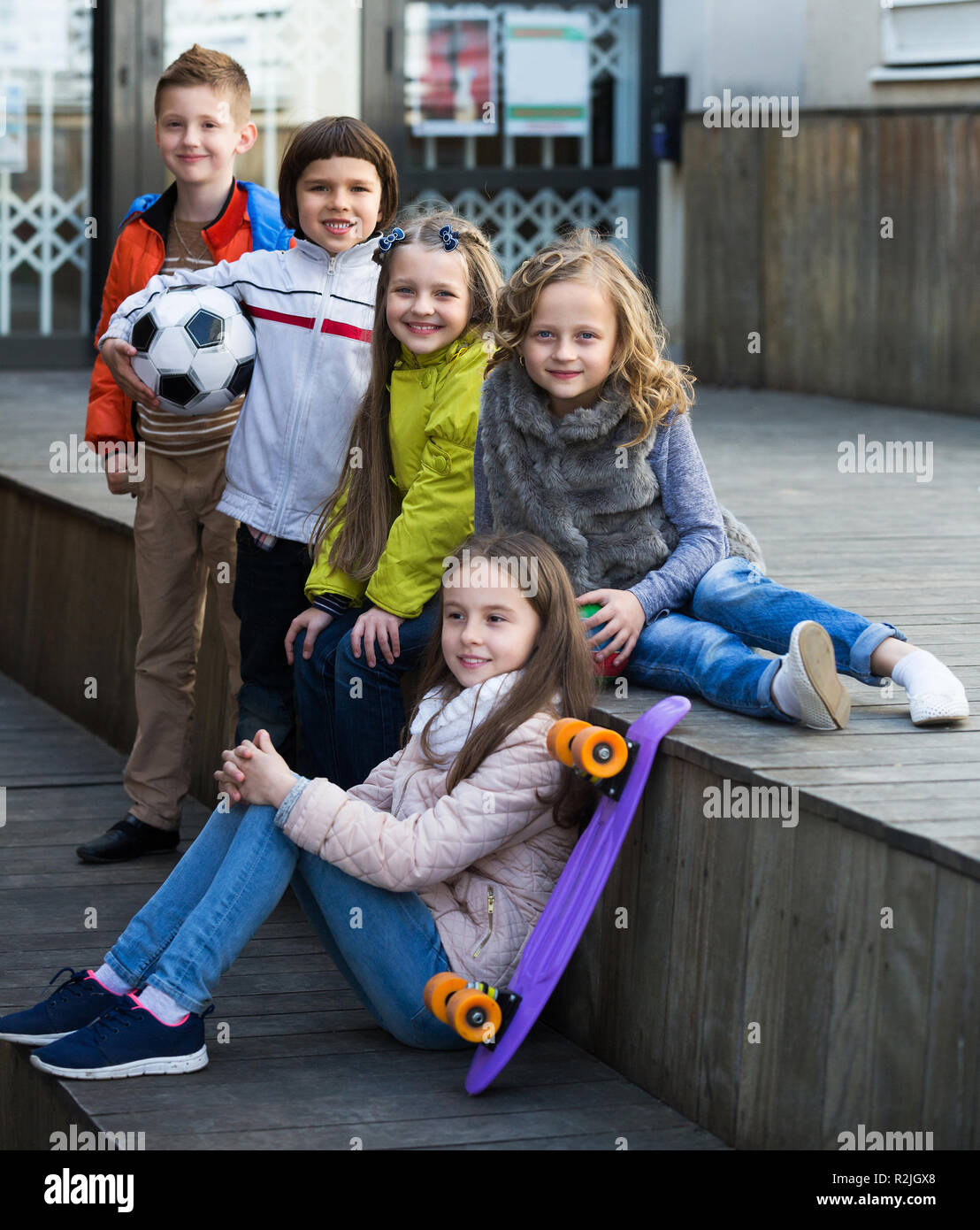 Portrait of happy junior school girls and boys in jackets Stock Photo ...