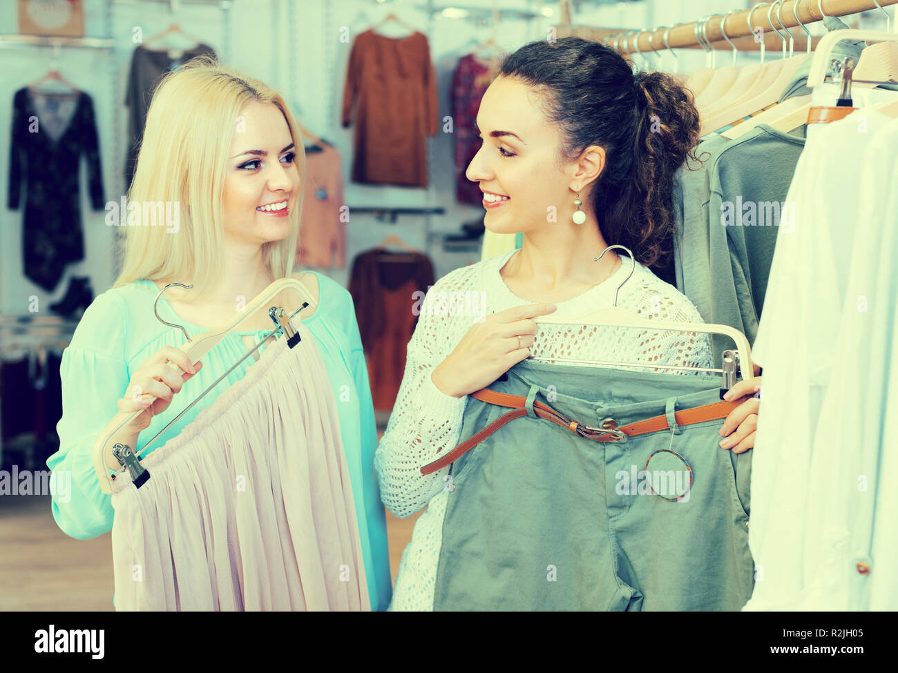 Smiling young consumers shopping at the clothing store Stock Photo - Alamy