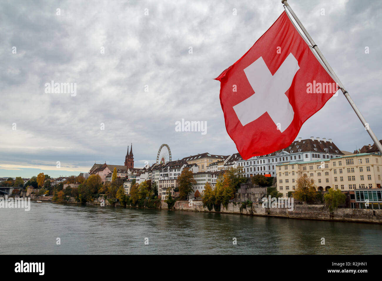 Swiss flag over the river Rhine in Basel, with the Munster and ferris ...