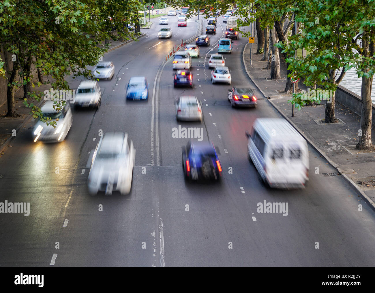 traffic on a four lane city street at evening Stock Photo - Alamy