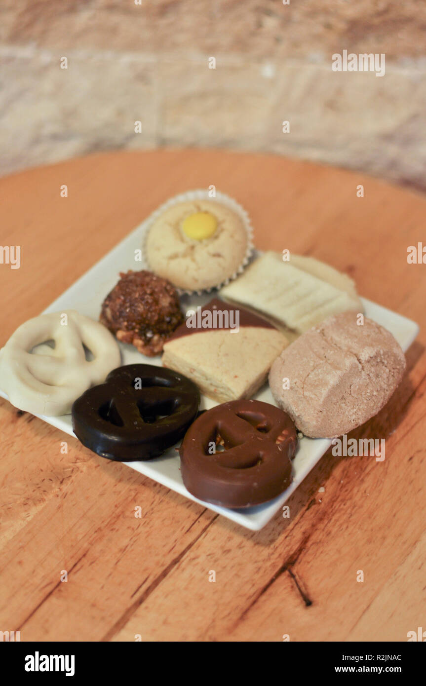Mix small sweet pastries served with tea Stock Photo - Alamy