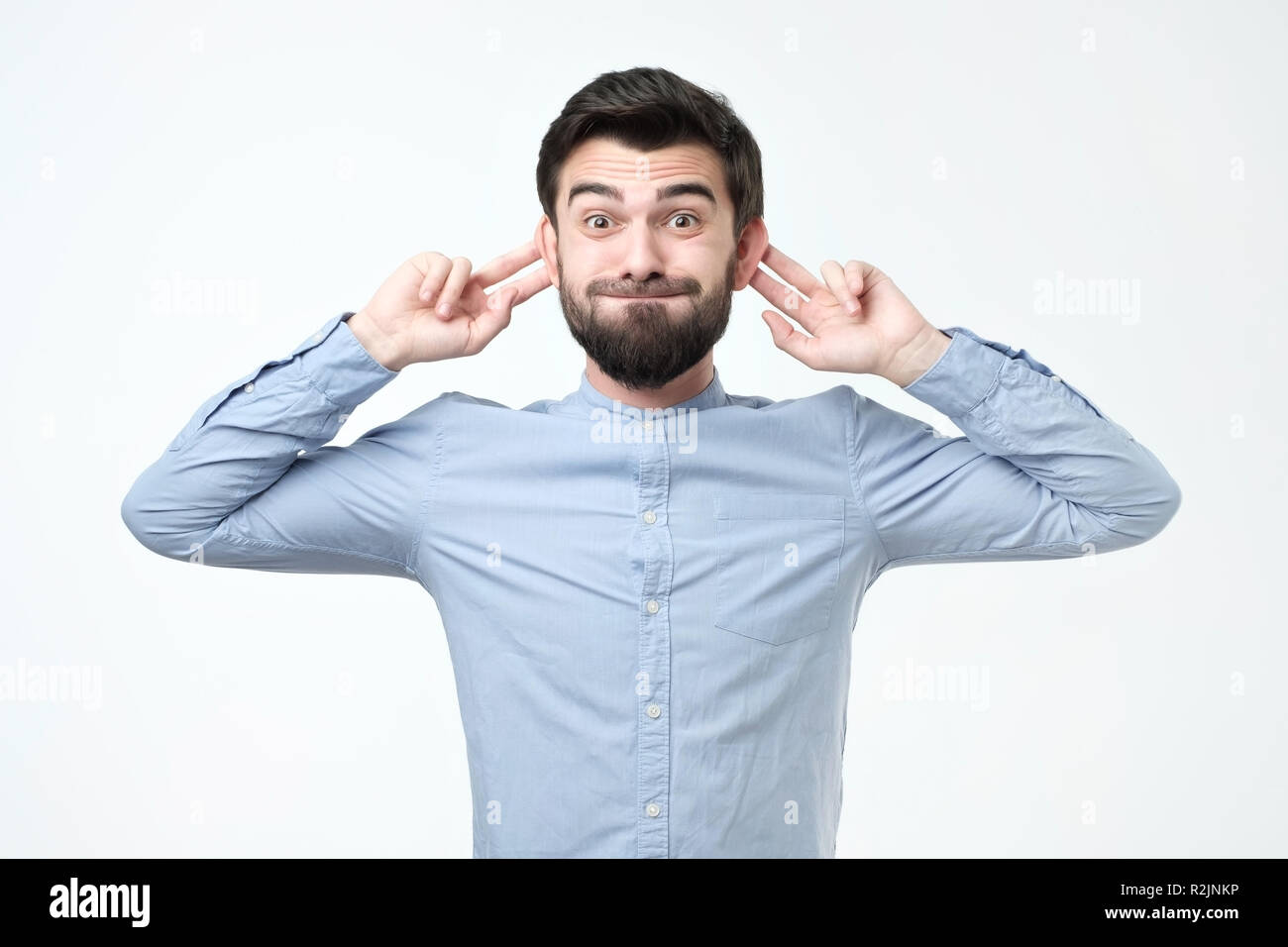 Hispanic man with funny monkey face over gray background Stock Photo ...