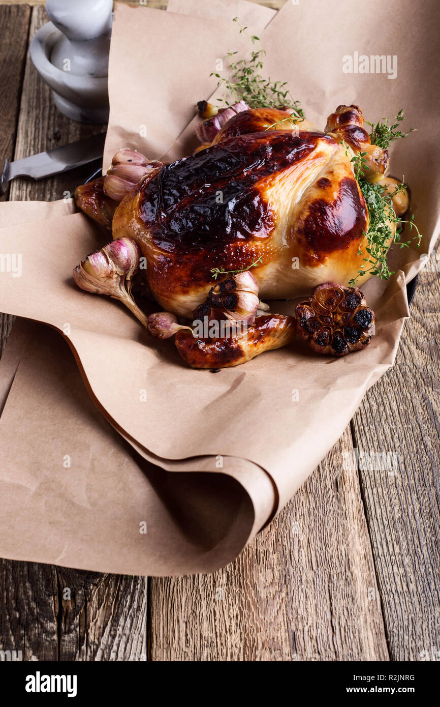 Spicy grilled chicken with garlic and thyme on craft paper ready to eat ...