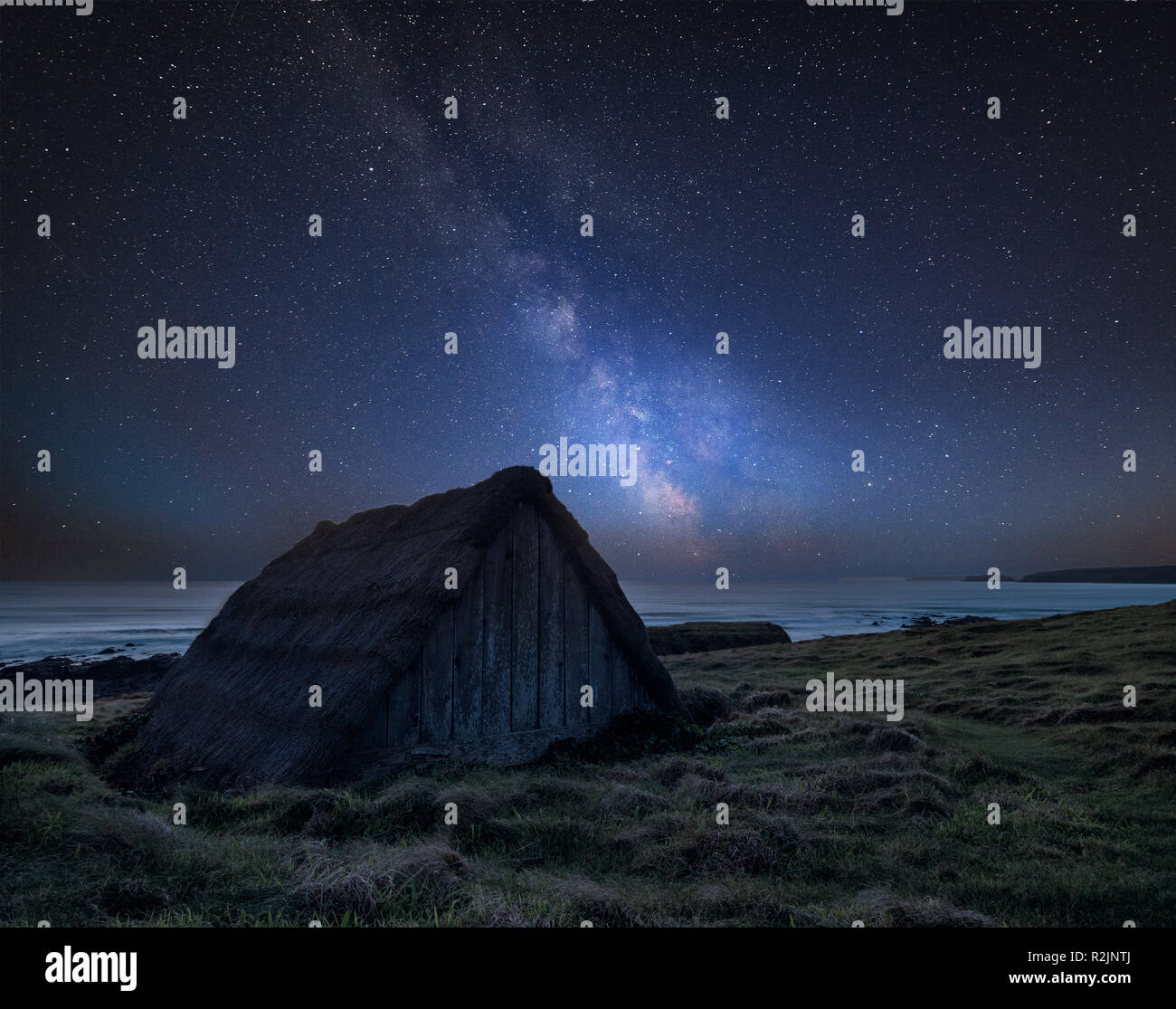 Stunning vibrant Milky Way composite image over landscape of seaweed ...