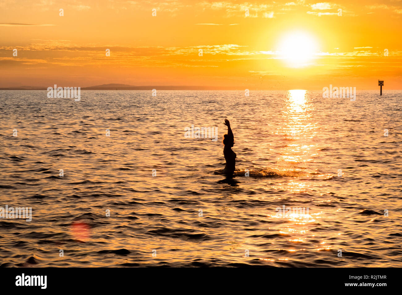 Female person bathing at sunset in Lake Constance Stock Photo - Alamy