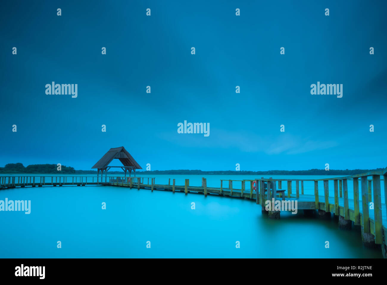 Jetty with thatched roof at the lake Stock Photo - Alamy