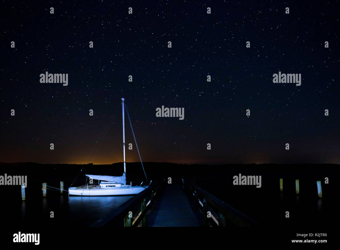 Sailboat at the jetty on a starry night hi-res stock photography and ...