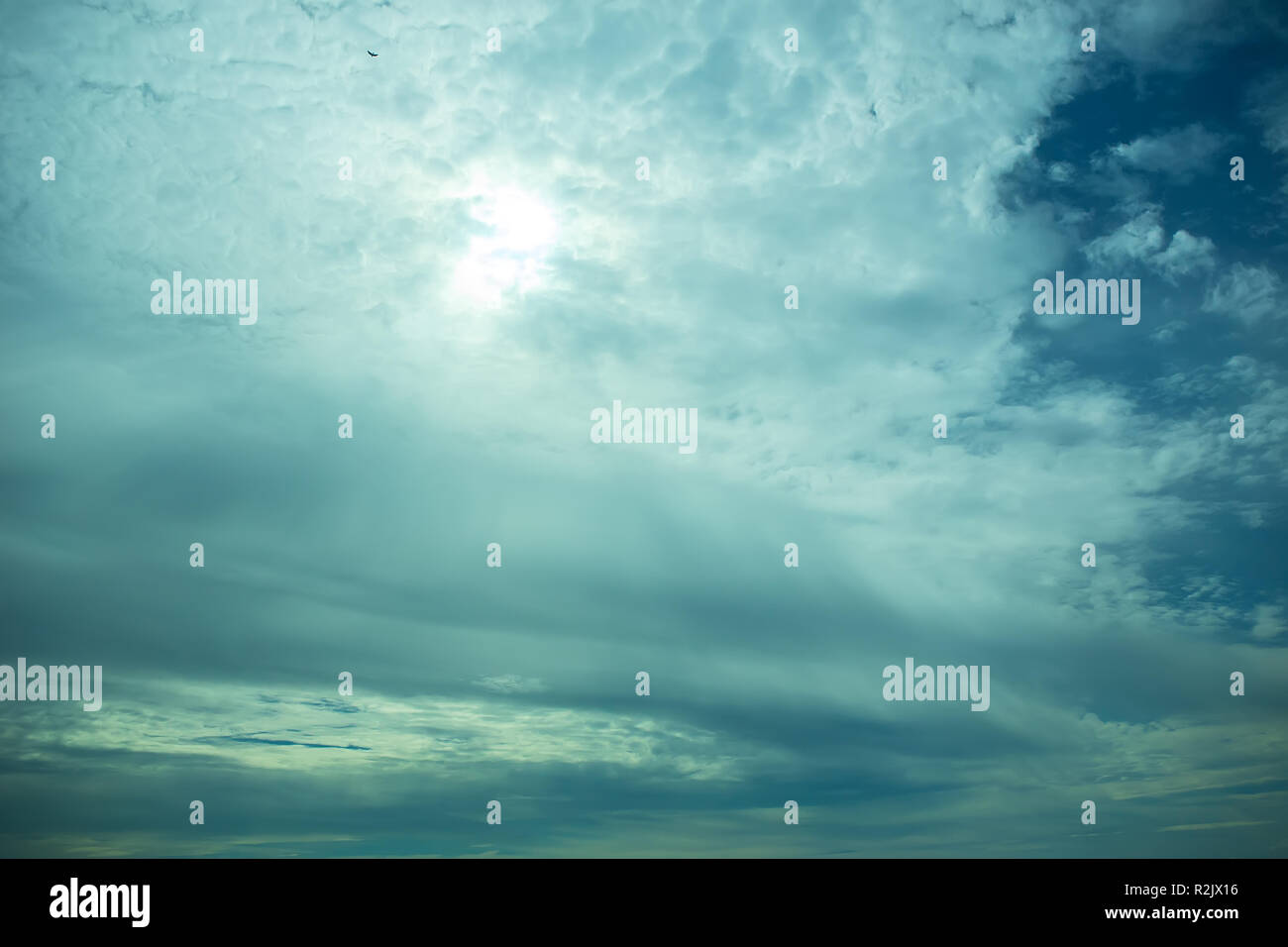 Sun beam breaking through dark clouds Stock Photo - Alamy