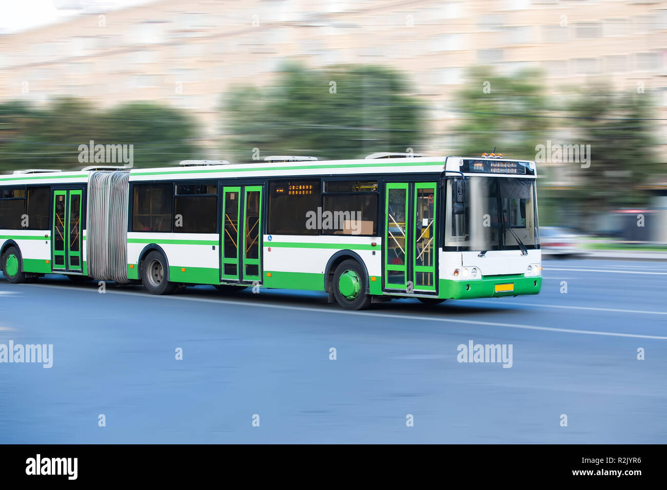 white city bus goes along street Stock Photo - Alamy