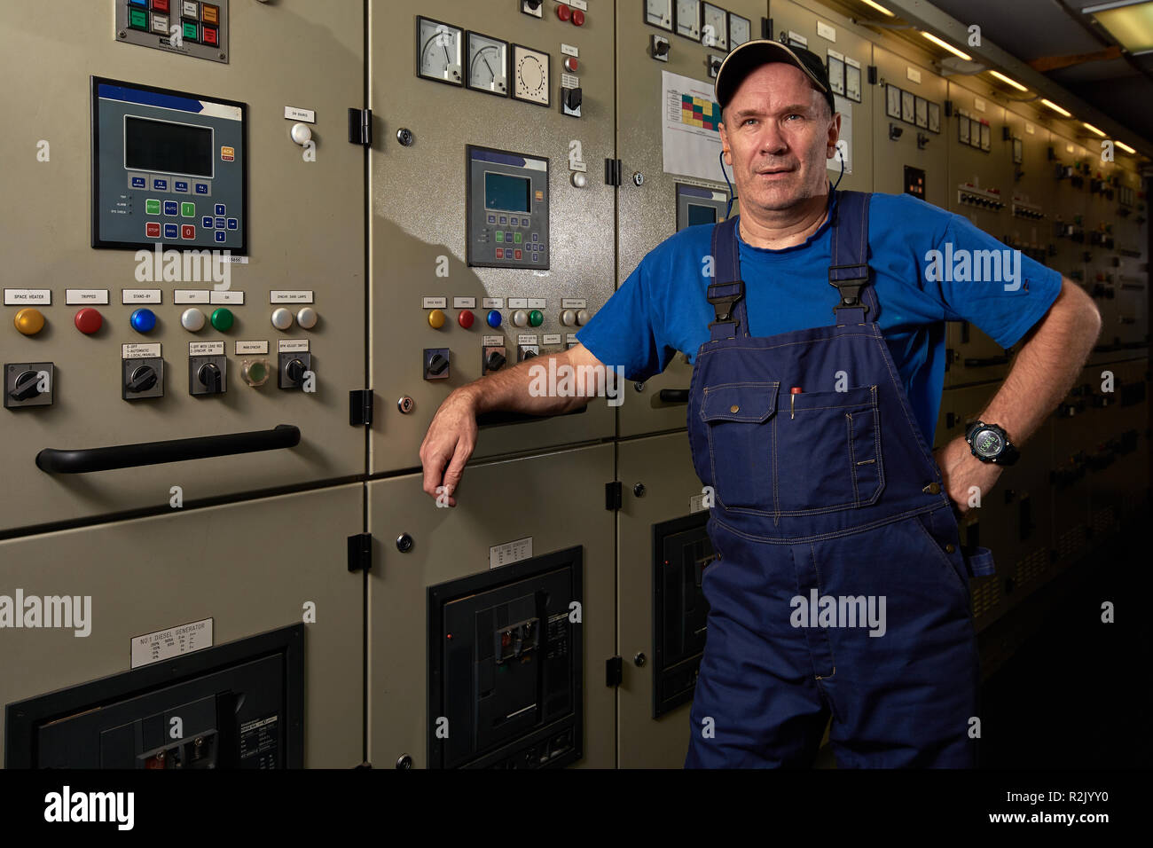 Proud and happy mechanic / chief engineer, posing with his arms crossed ...