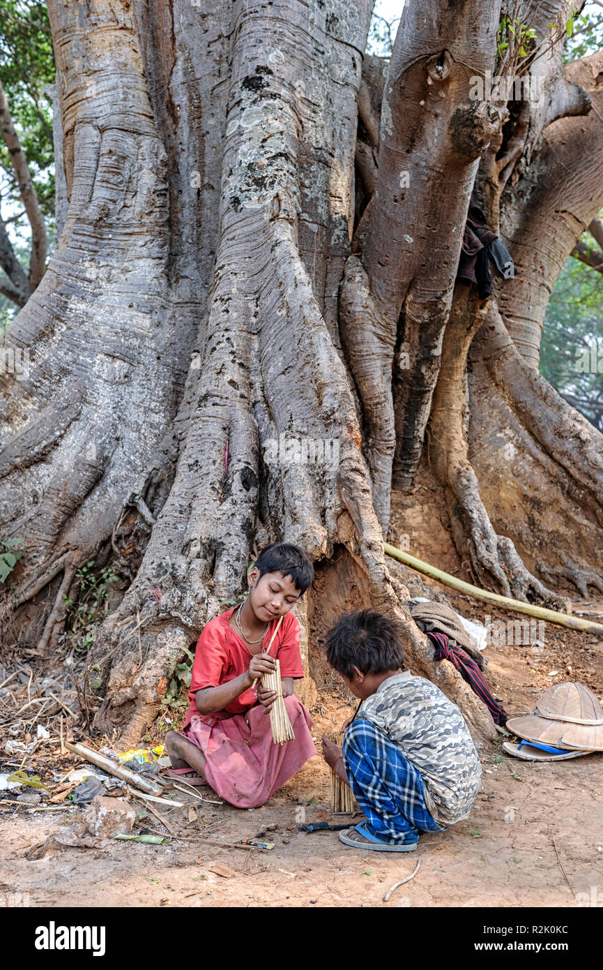 Children playing near the roots of a banyan tree in Pindaya, Shan ...