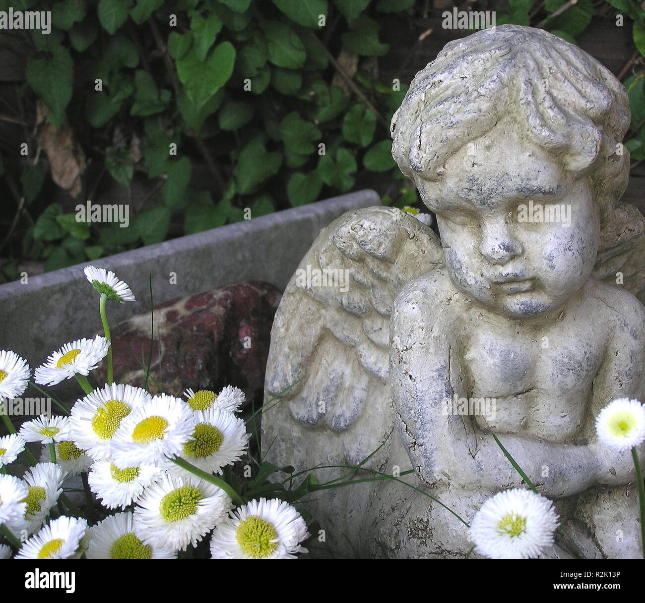 Little angel with flowers hi-res stock photography and images - Alamy