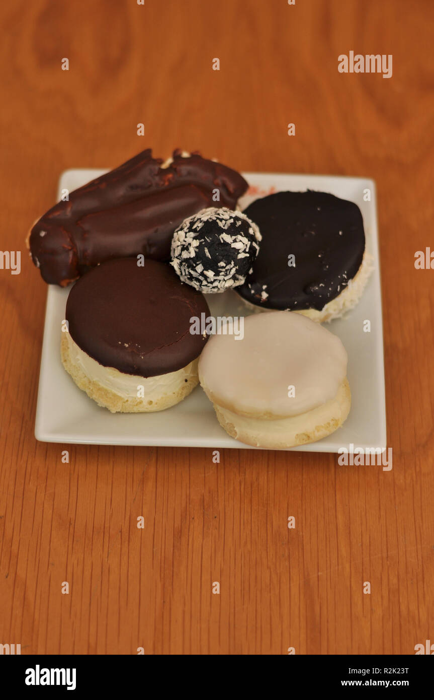 Fresh delicious small mix eclairs, creamy cakes Stock Photo - Alamy