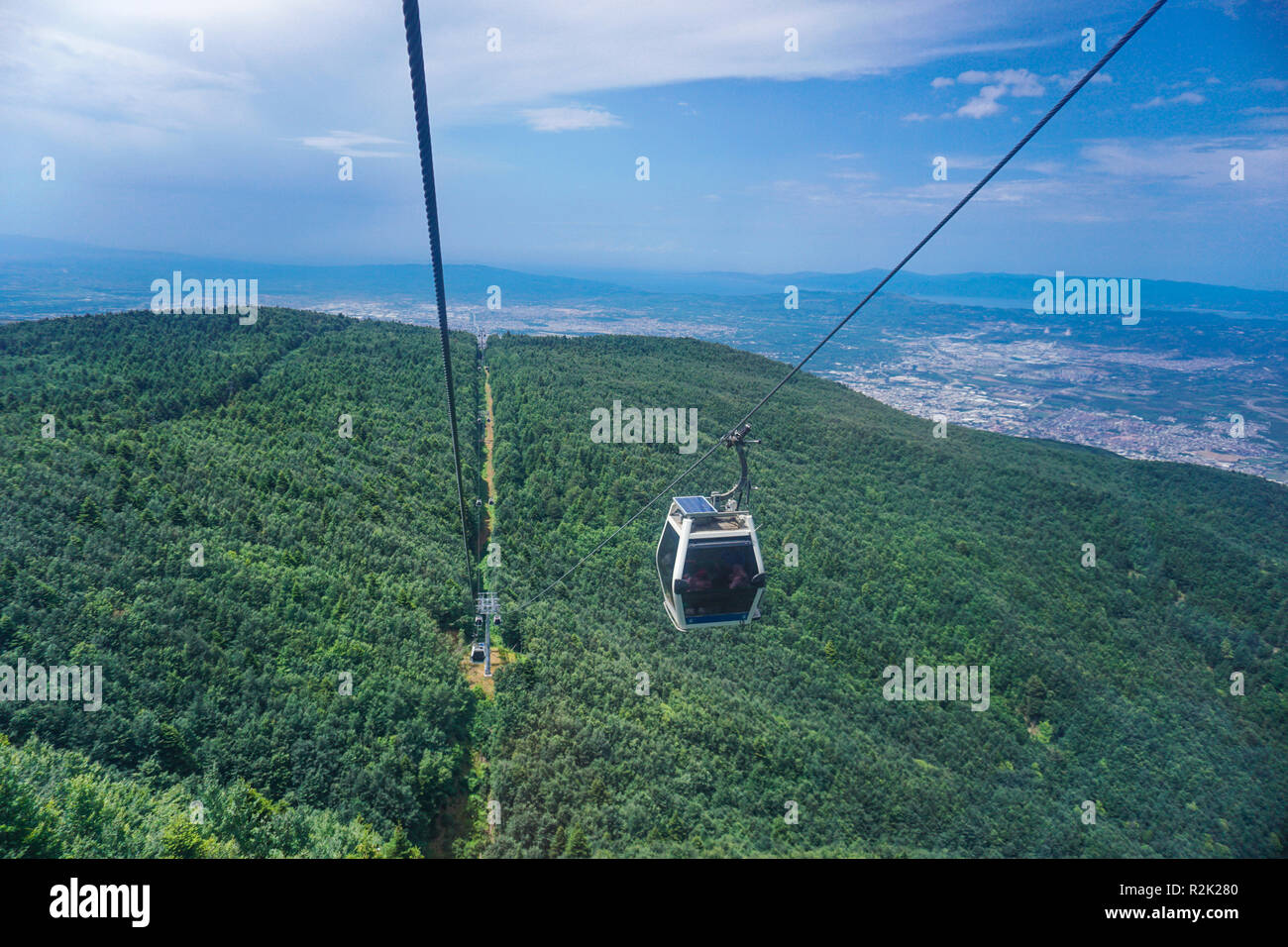 Cable cars going up in to the mountain, green hills Stock Photo - Alamy