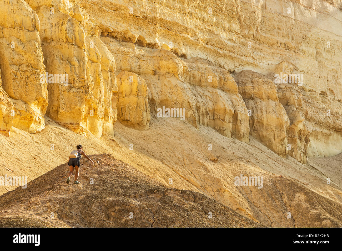 Girl climbing a canyon mountain in the Namibe Desert. Africa. Angola ...