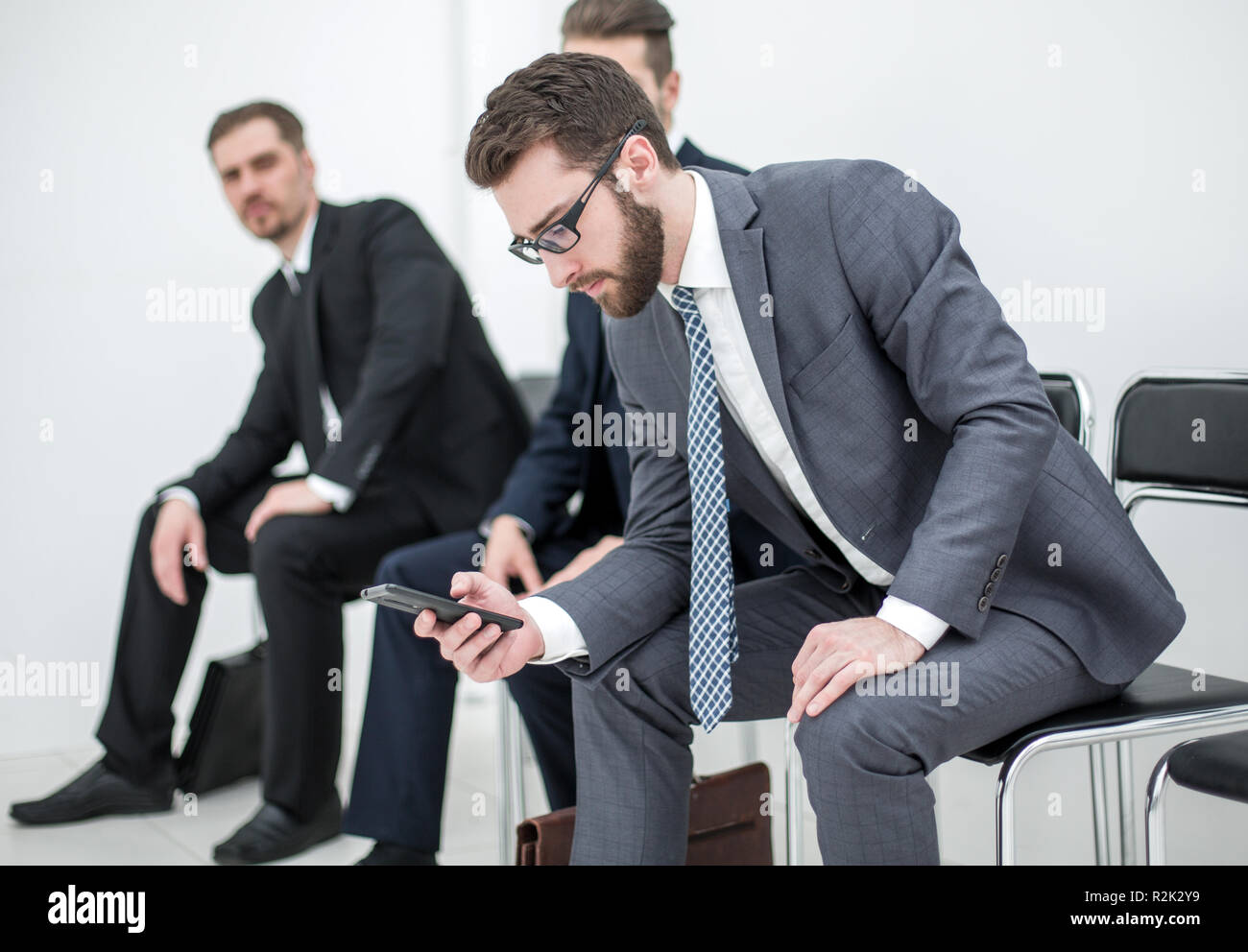 group of business people waiting for a meeting sitting in the office ...