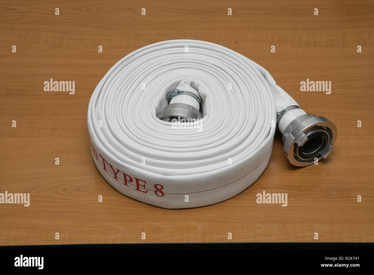 A shot of a white fire hydrant hose Stock Photo - Alamy
