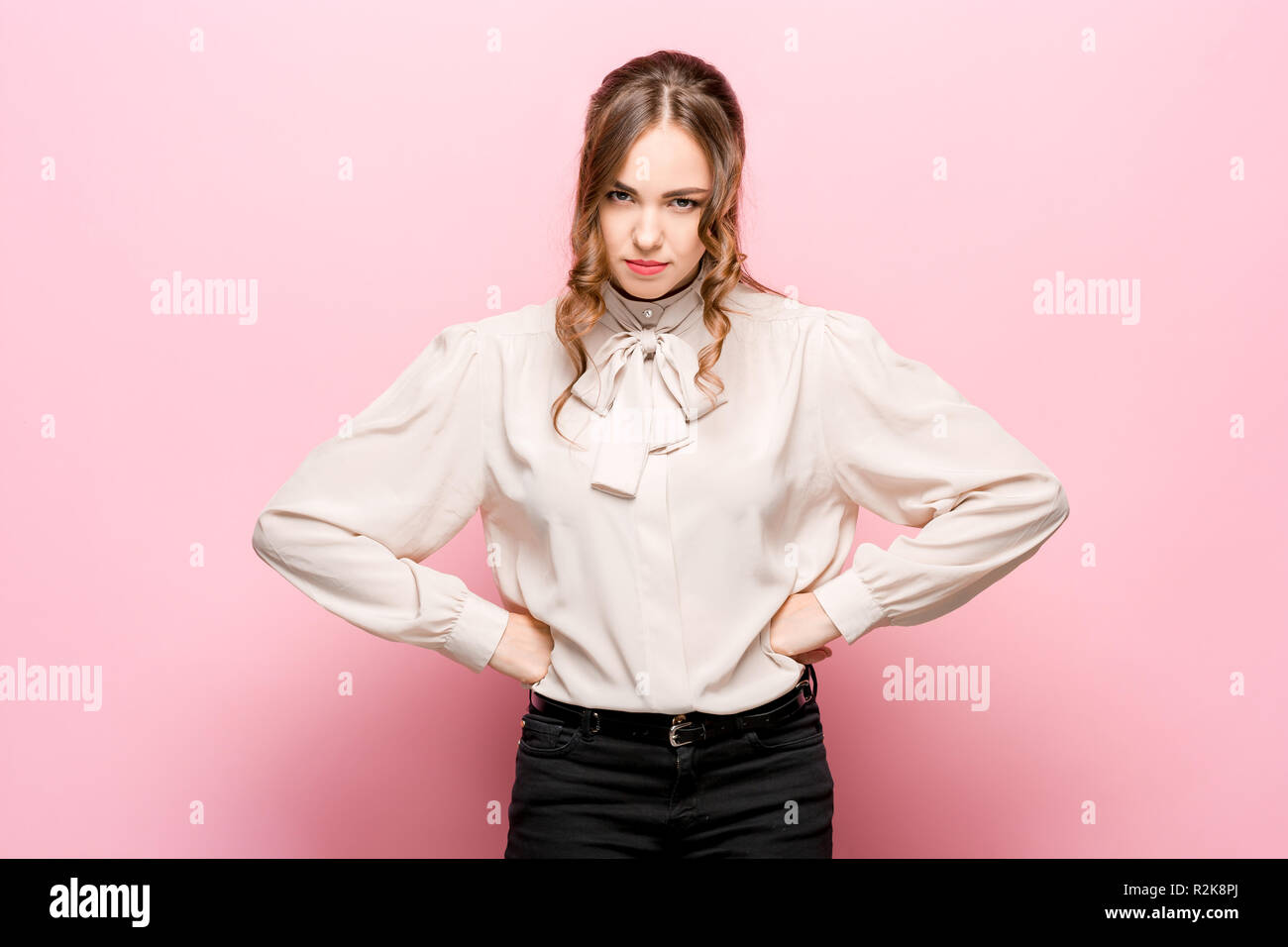 What is it. The female portrait isolated on pink studio backgroud ...