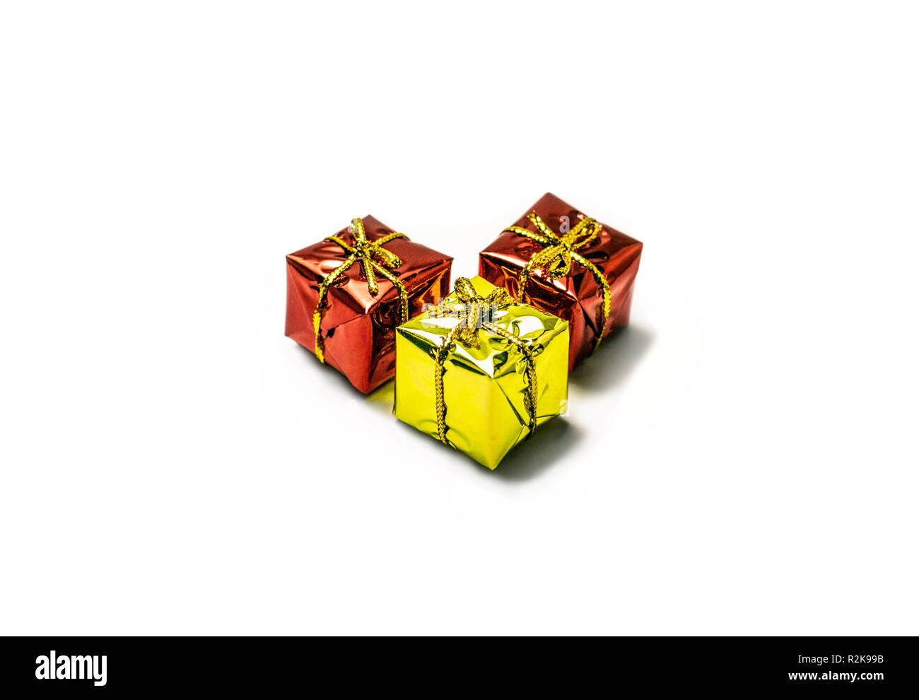 Three presents, two red and one yellow with ribbons isolated on white ...