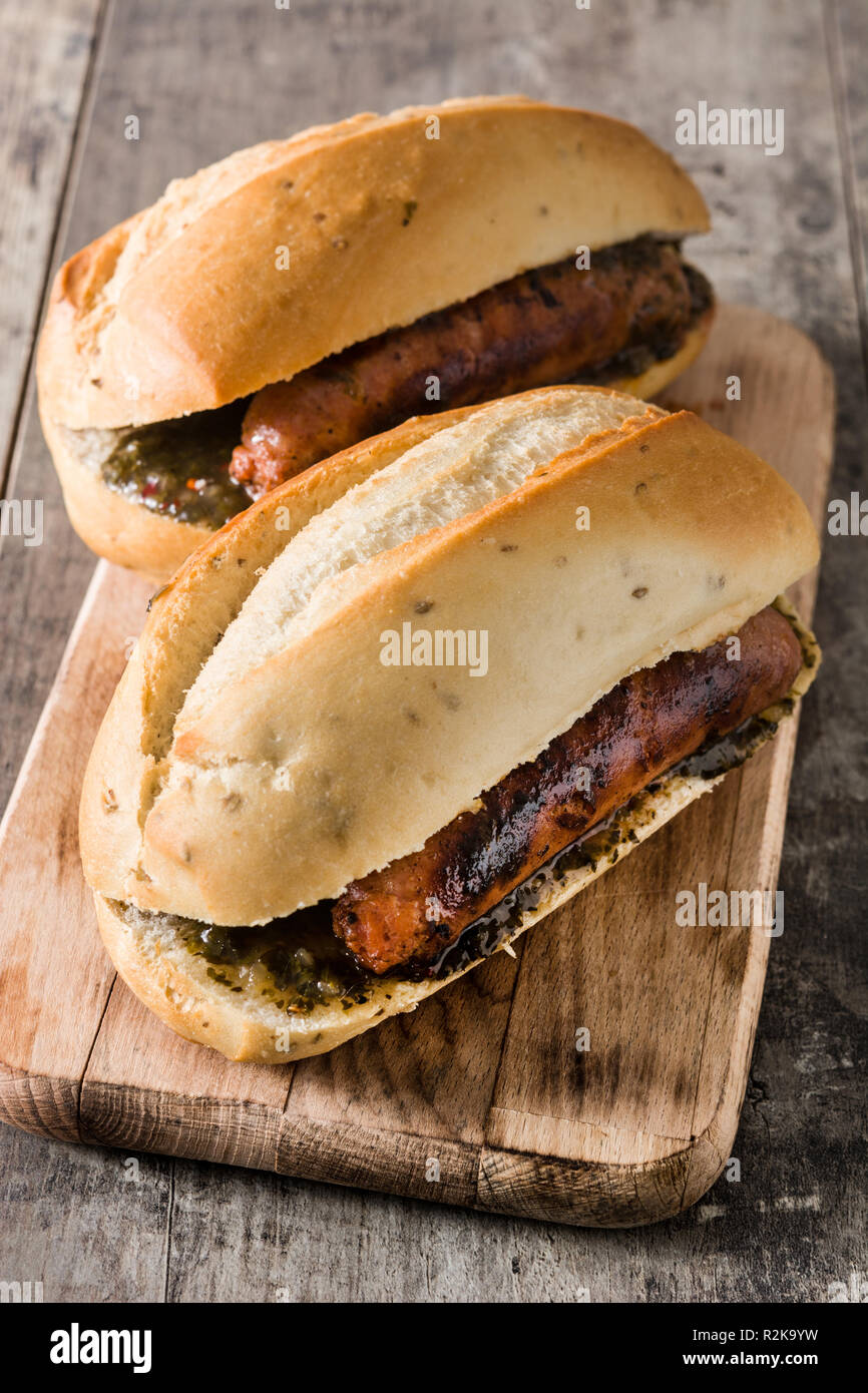 Choripan. Traditional Argentina sandwich with chorizo and chimichurri ...